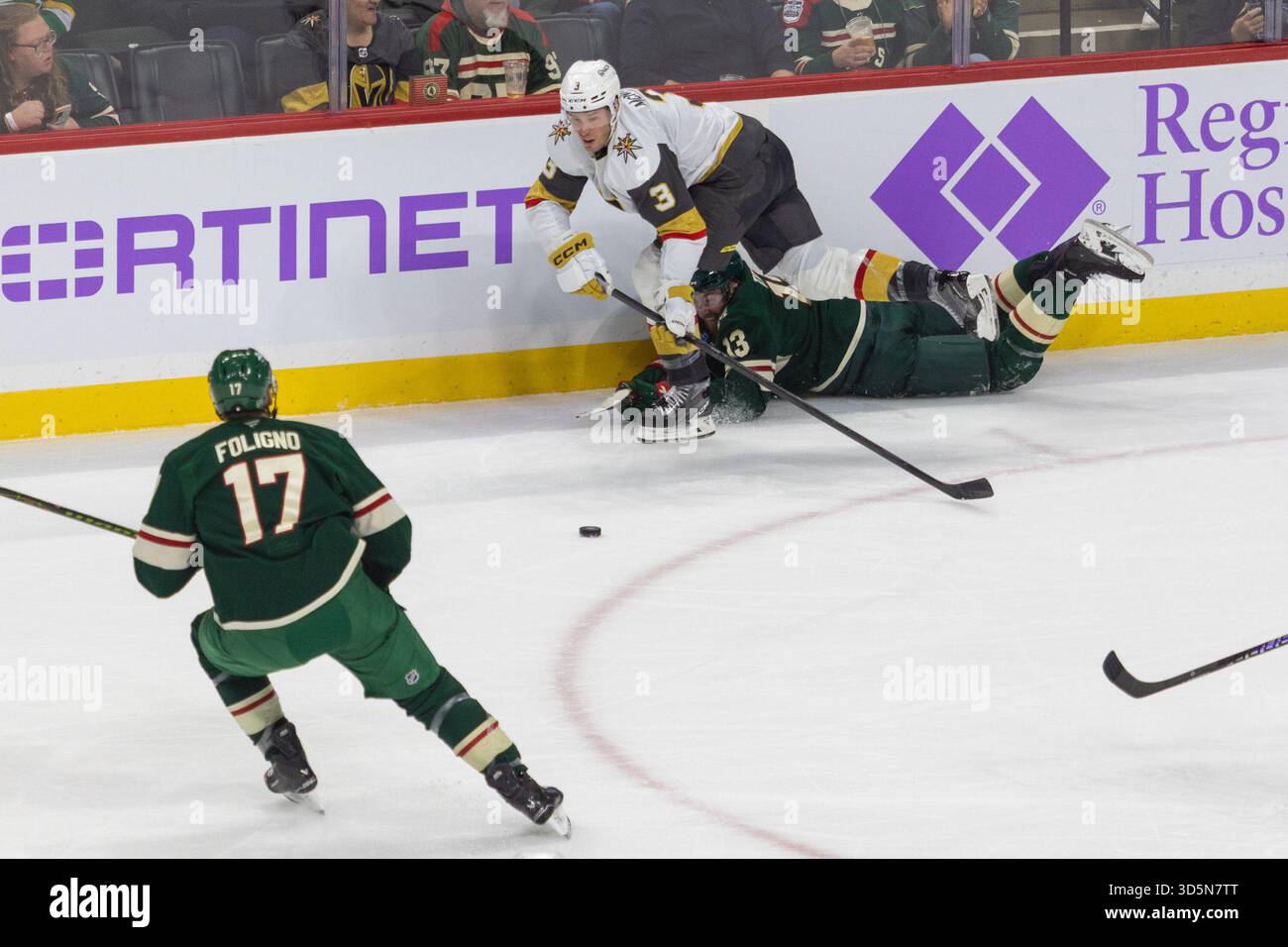 Minnesota Wild player Yakov Trenin, right, slides under Vegas Golden ...