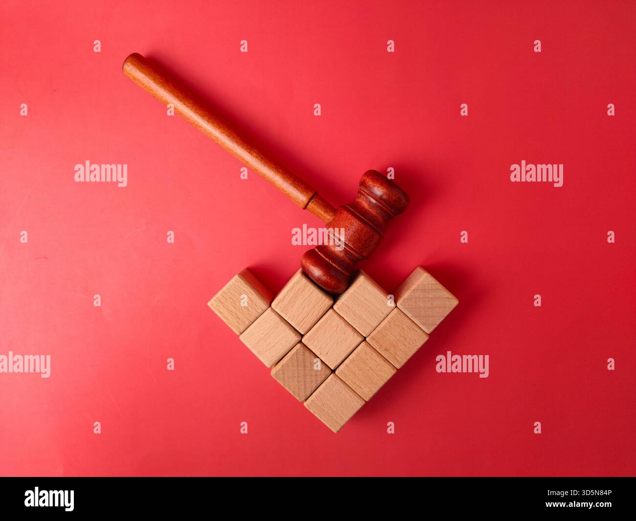 The image features a wooden gavel resting on a structure of small ...