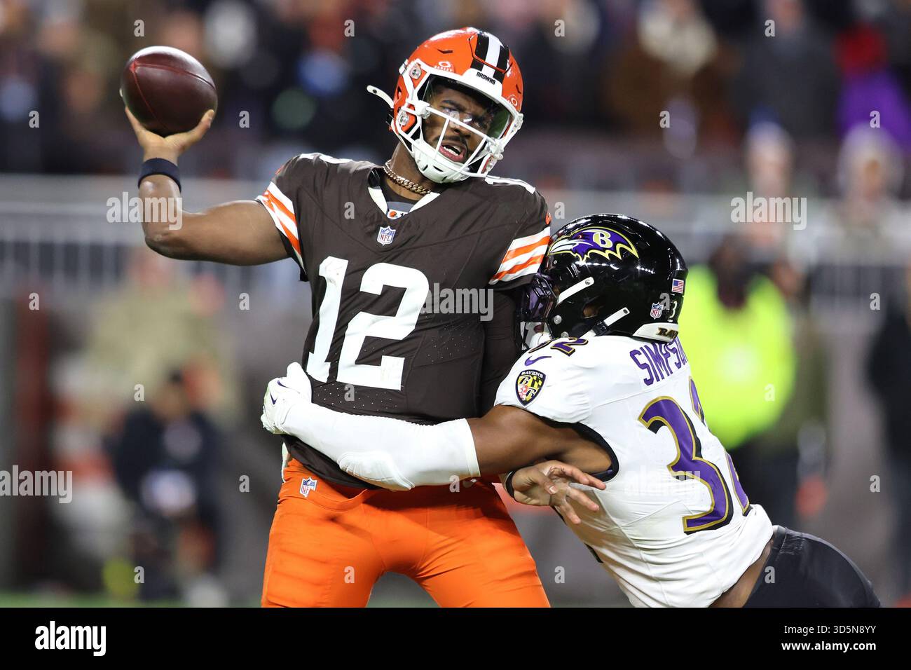 Cleveland Browns Shedeur Sanders (12) throws as he is hit by Baltimore ...