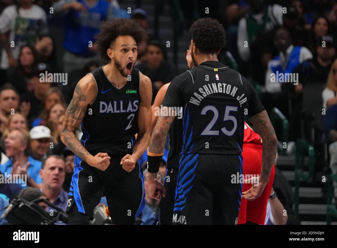 Dallas Mavericks center Dereck Lively II, left, reacts with teammate ...