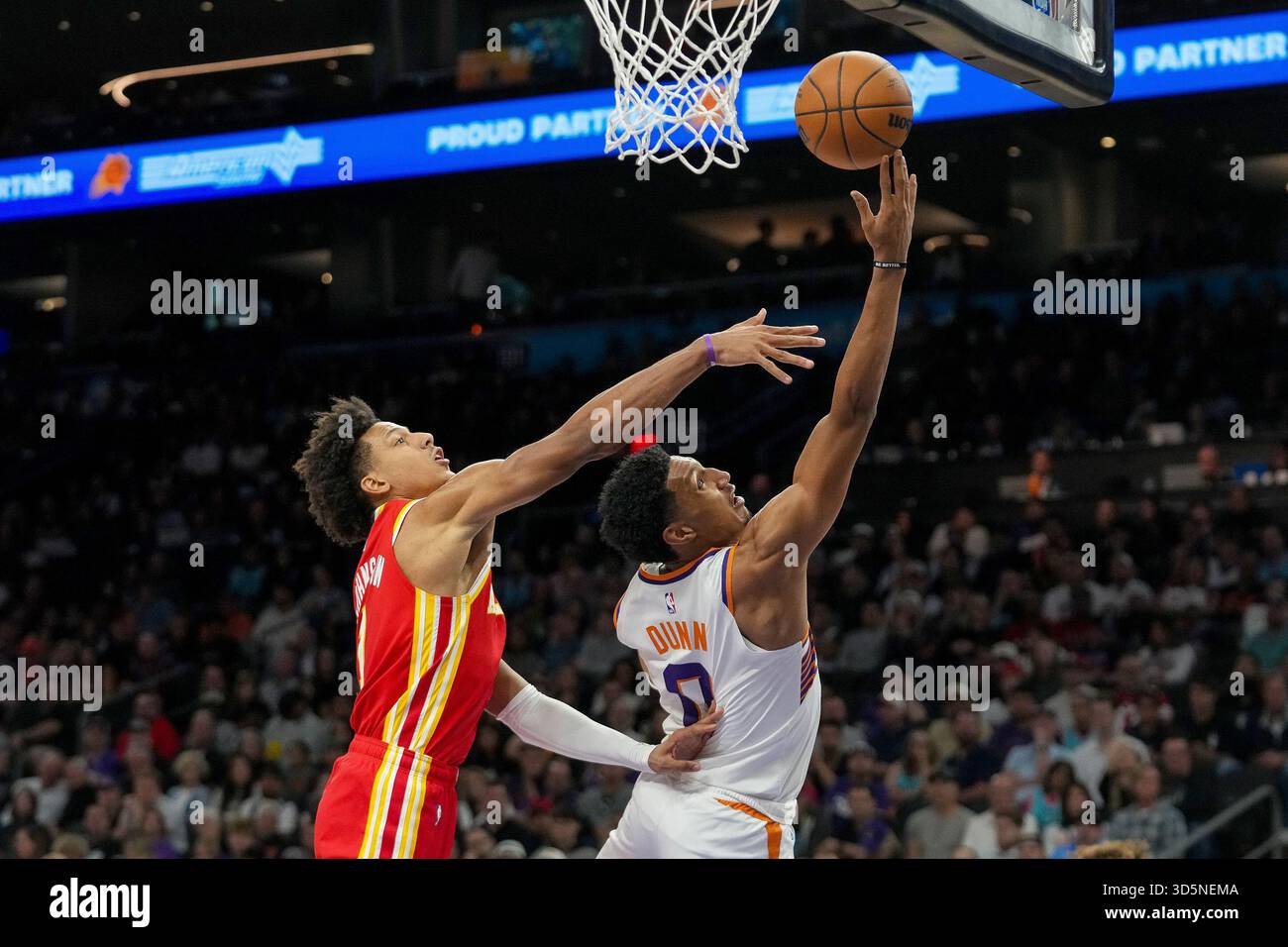 Phoenix Suns forward Ryan Dunn, right, puts up a shot against Atlanta Hawks forward Jalen ...