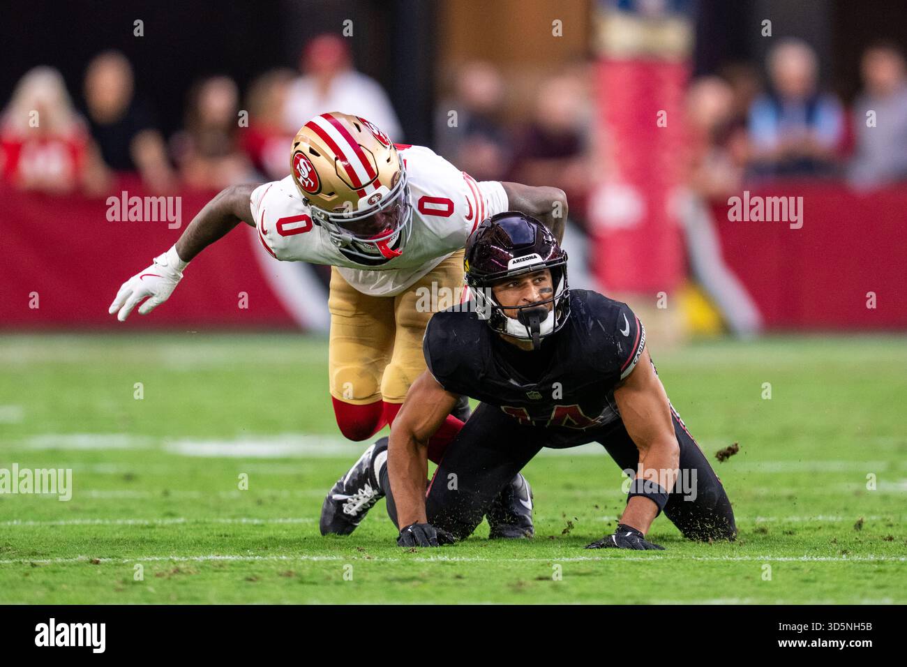 San Francisco 49ers cornerback Renardo Green (0) trips over Arizona ...