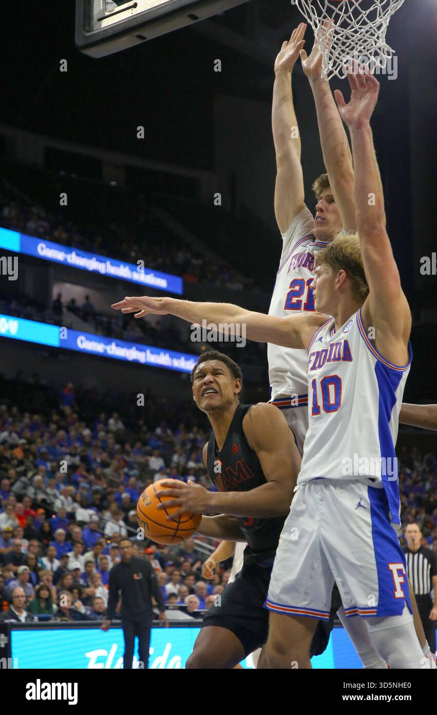 Miami's Malik Reneau, left, goes up against Florida's Alex Condon ...