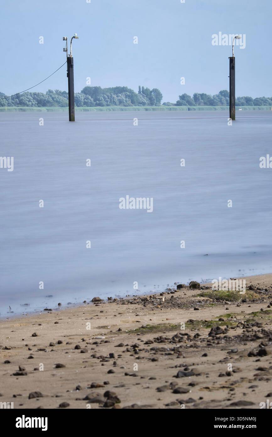 Light poles in the water at a lake next to Geltow, Germany on a sunny ...