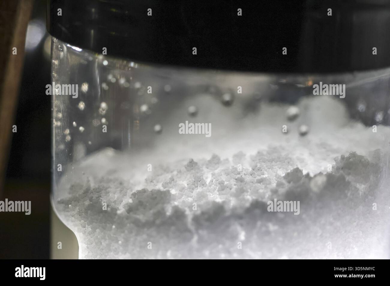Fascinating macro view of white salt crystal dissolving in transparent ...