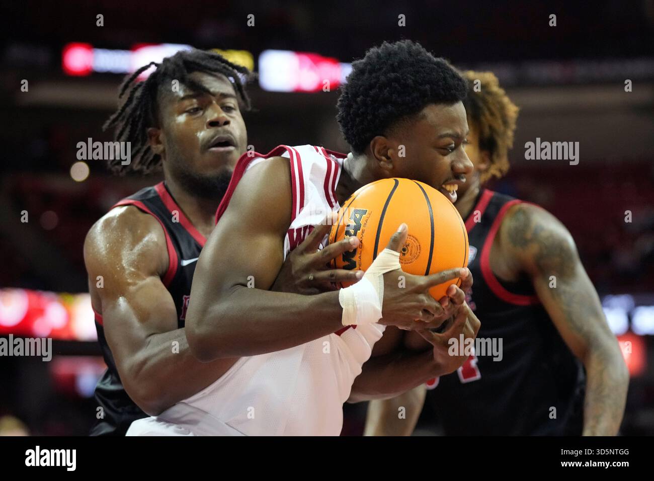 Wisconsin guard John Blackwell, right, holds onto the ball against Ball ...