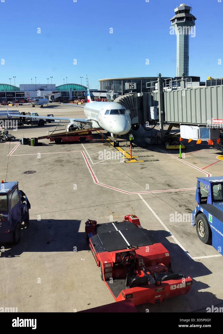 Embraer jet in American Eagle livery parked at the passenger bridge at ...