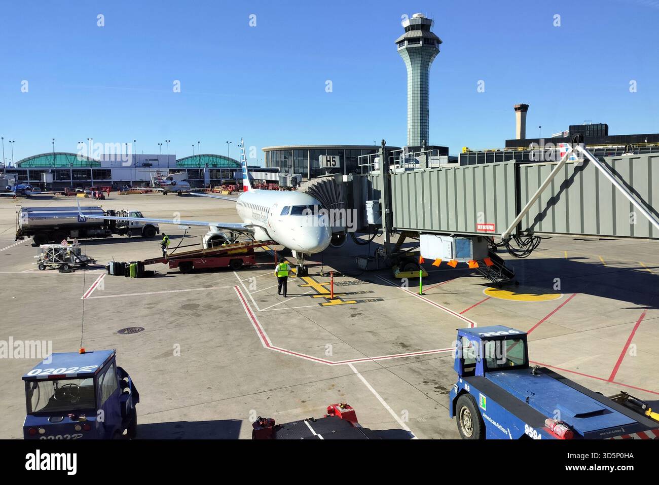 Embraer jet in American Eagle livery parked at the passenger bridge at ...
