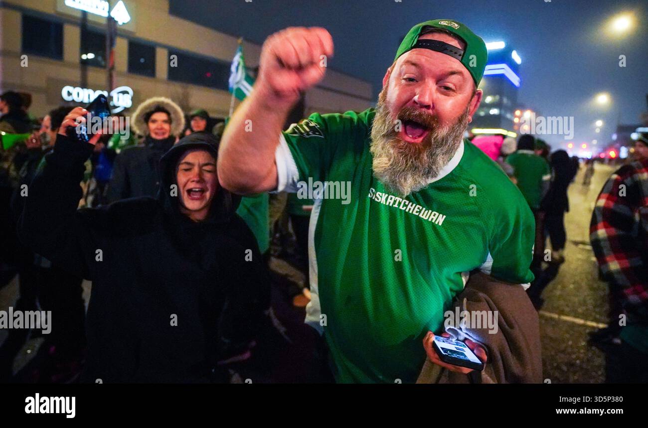 People cheer in a street party after the Saskatchewan Roughriders ...