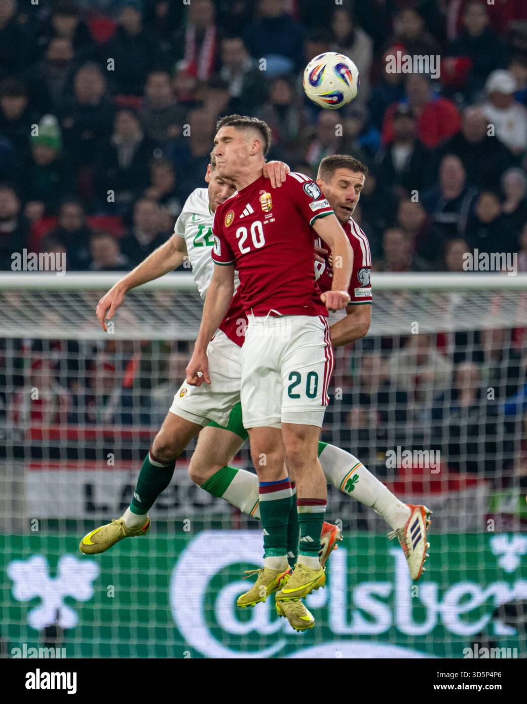 Roland Sallai of Hungary jumps for the ball with Barnabás Varga of ...