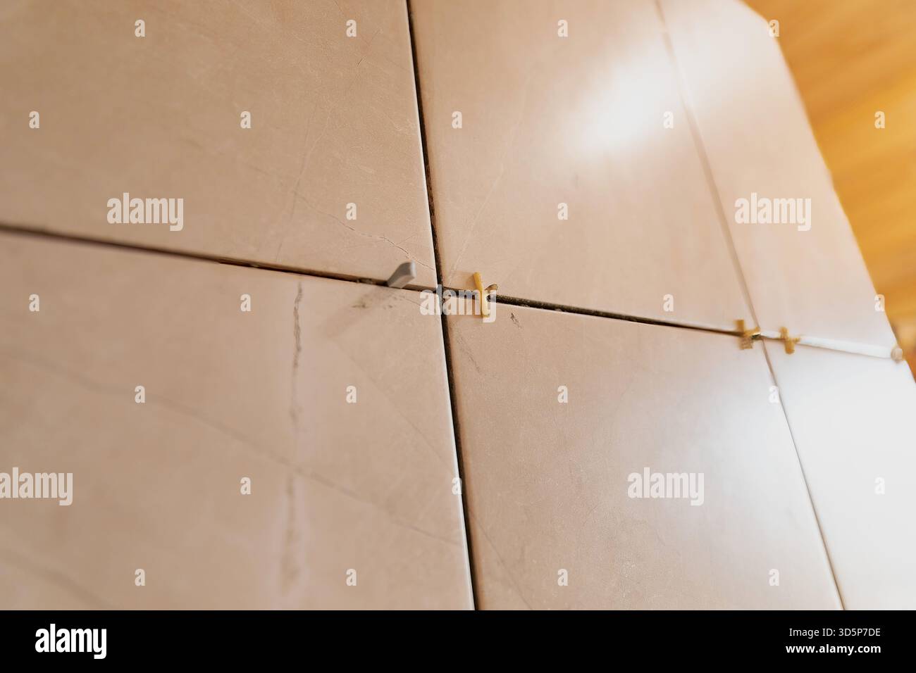 Ceramic wall tiles with spacers during installation in home interior ...