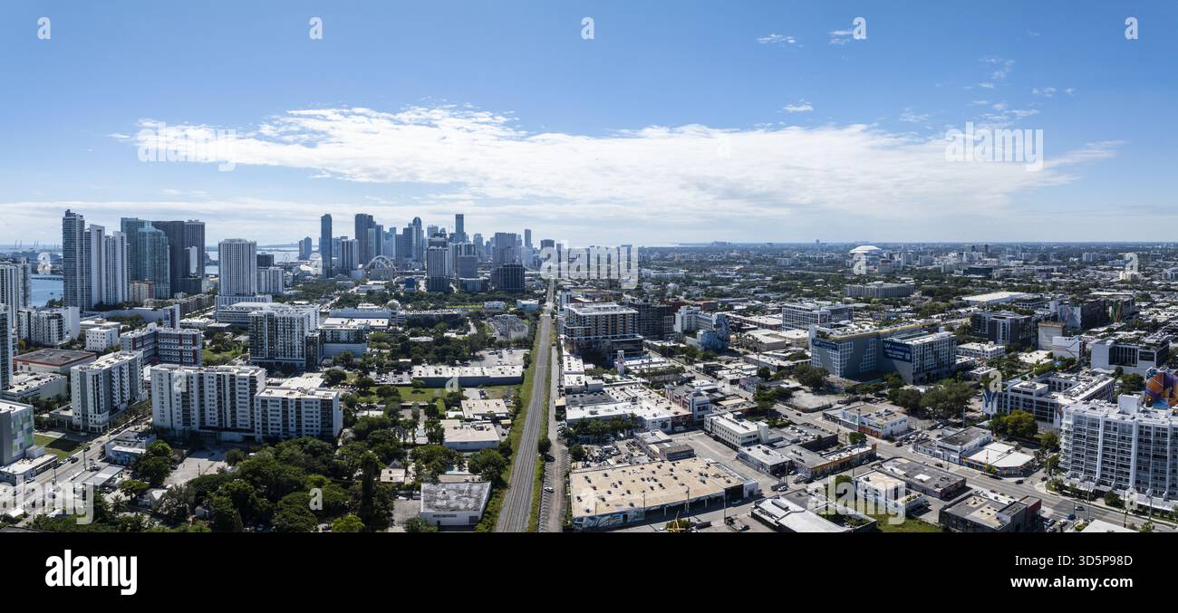 Aerial view of a sprawling cityscape where gleaming skyscrapers meet ...