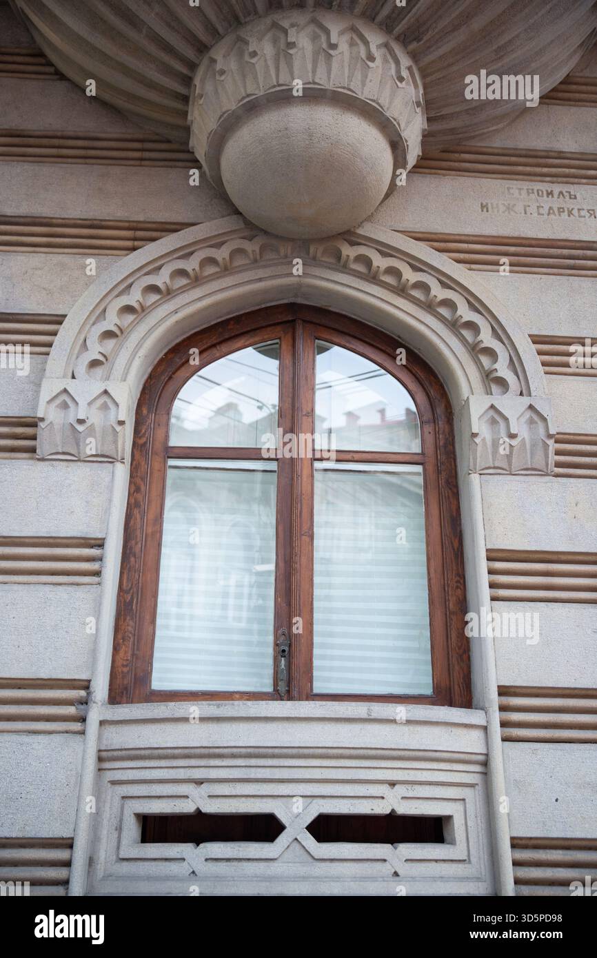 Ornate Arched Window with Stone Carvings on Historic Building Facade in ...