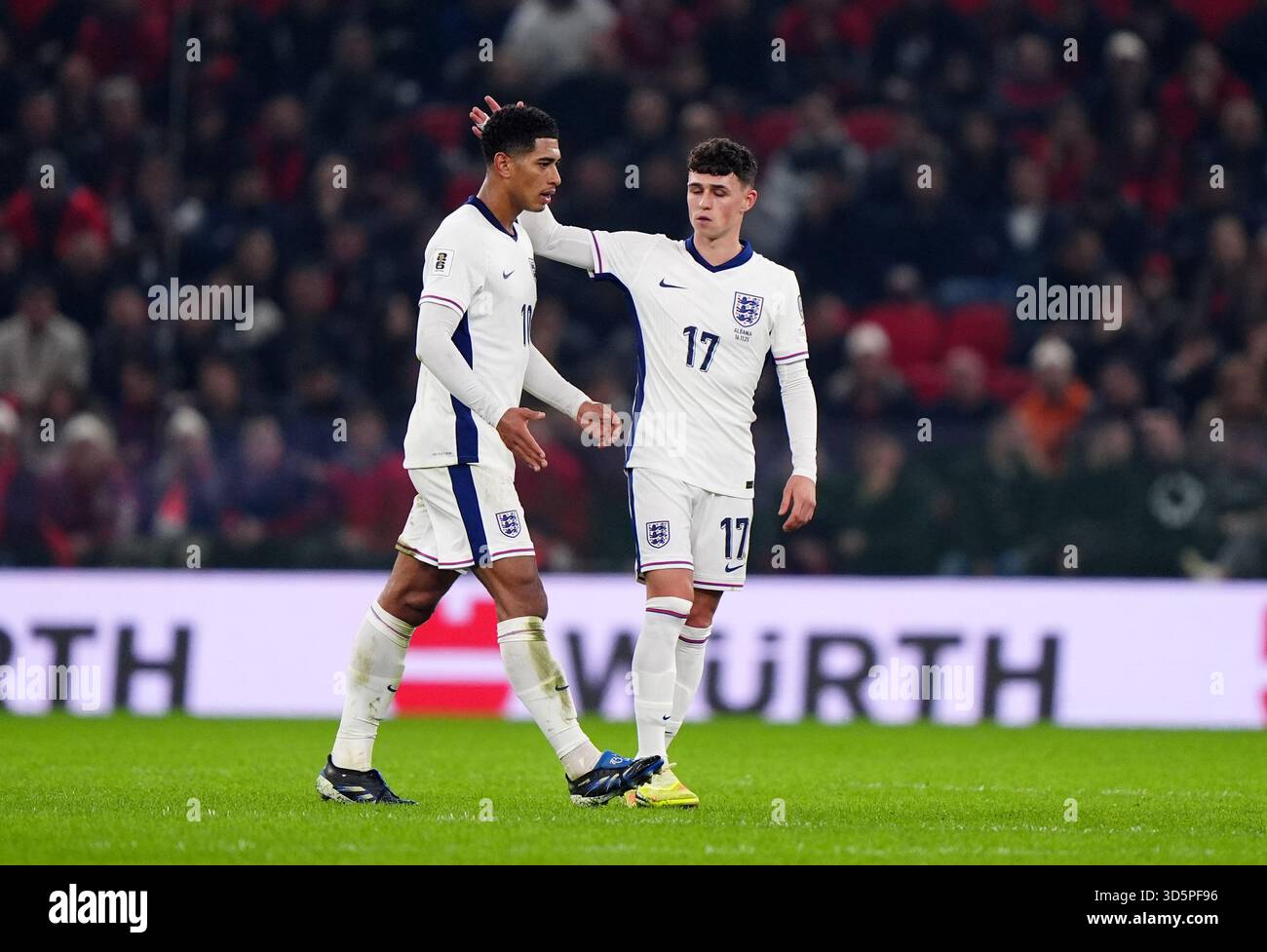 England's Jude Bellingham (left) with Phil Foden as he is substituted ...