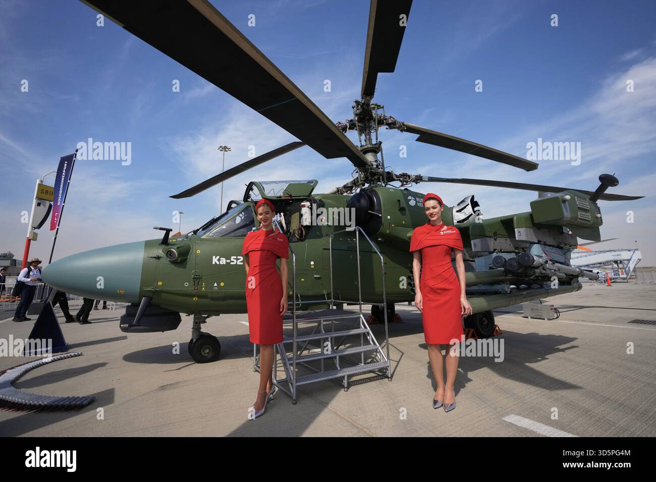 Russian hostesses stand by a Russian KA-52 attack helicopter at the ...