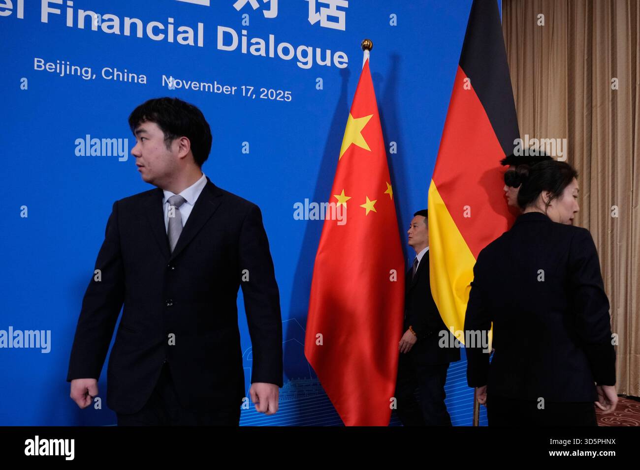 Workers prepare the flags for joint press conference by Chinese Vice ...