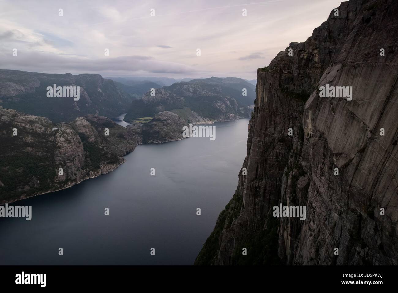 Aerial view of dark, still waters winding through imposing, jagged ...