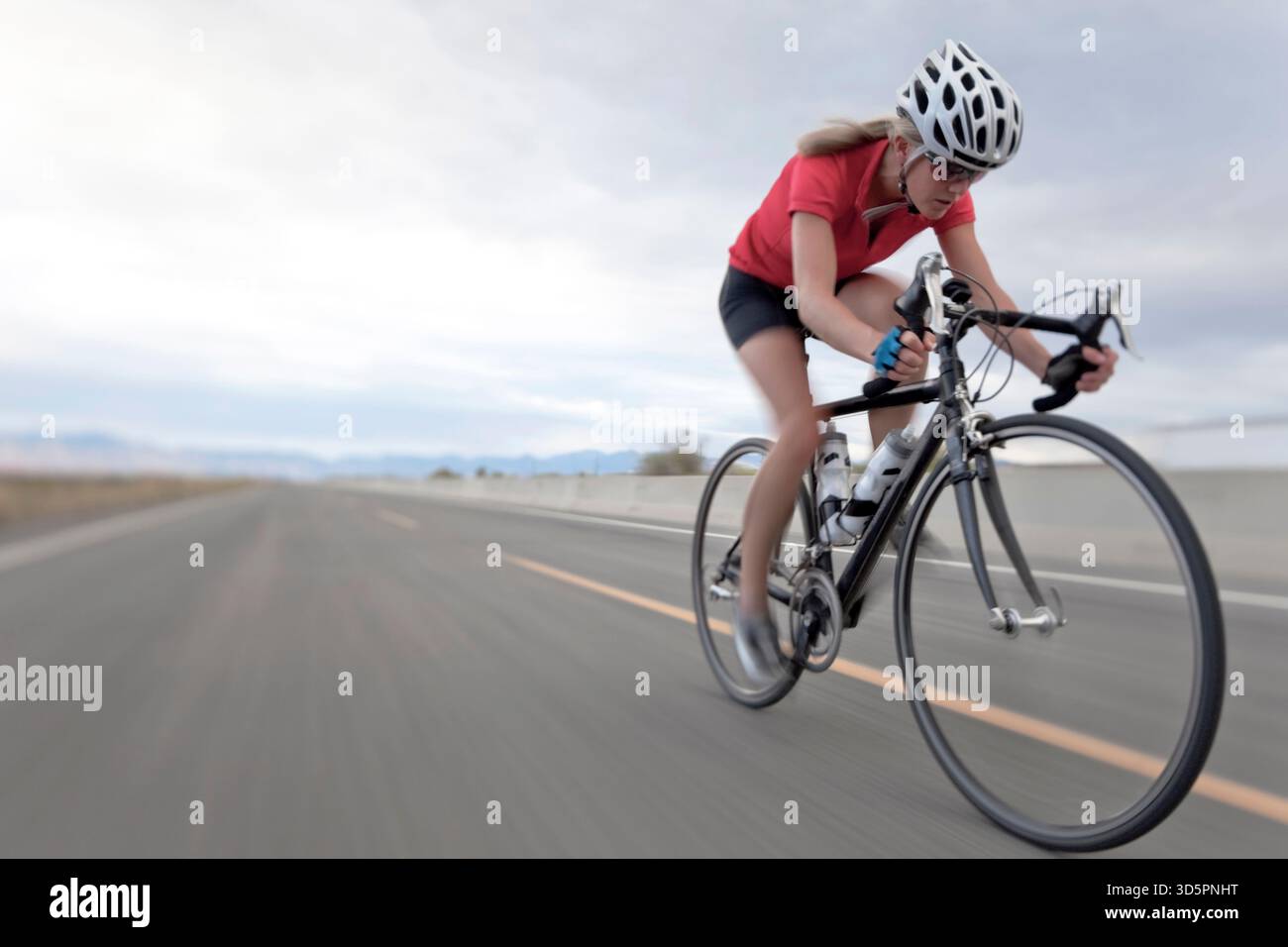 Girl cycles at top speed Stock Photo - Alamy