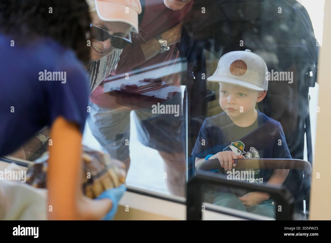 Through a picture window, Ryan Redding, 3, gets a closer look at a ...