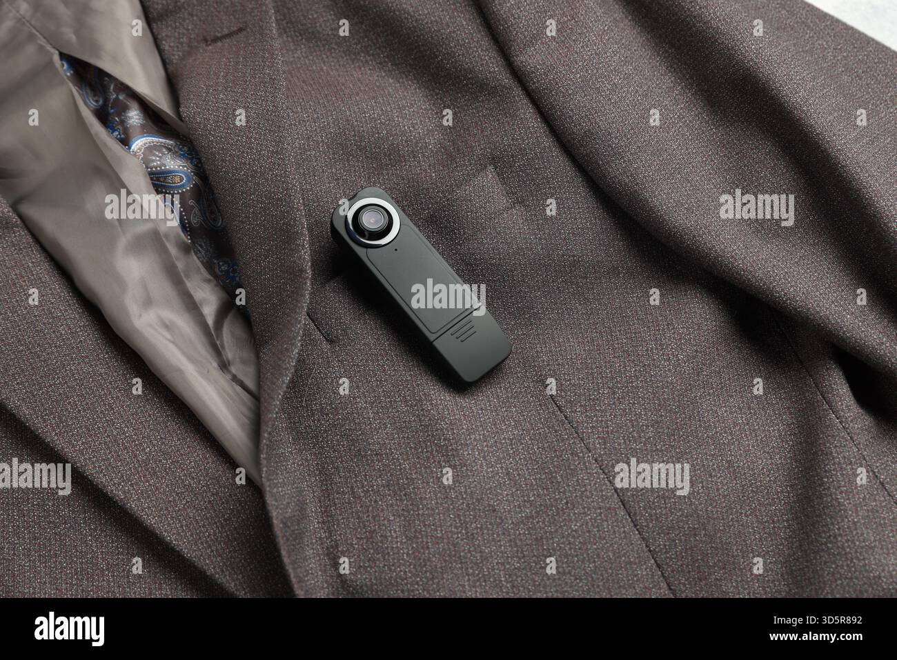 Hidden spy camera on jacket against light background, closeup Stock ...
