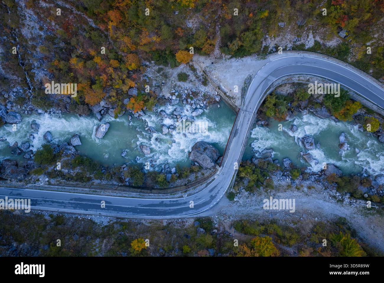 Aerial top-down view of a sharp mountain curve and the turquoise ...