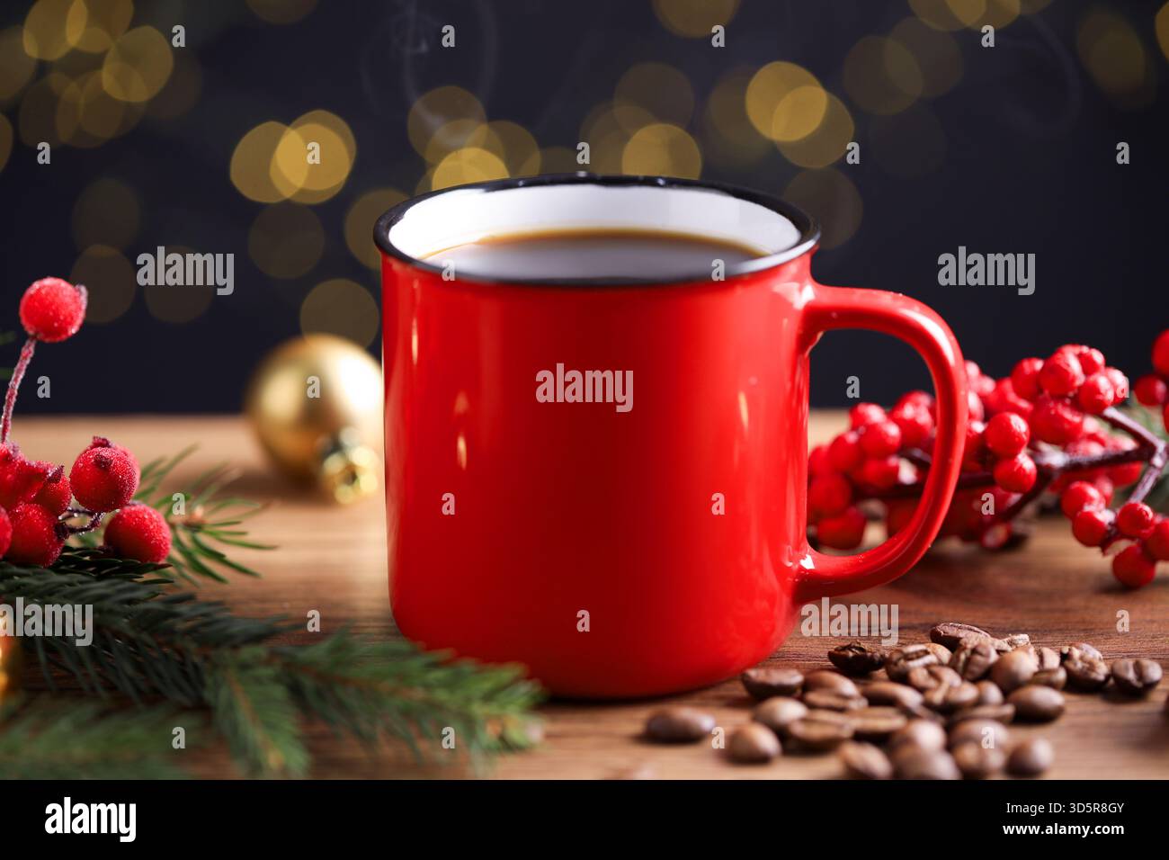 Aromatic coffee in red mug, beans, berries and fir tree branches on ...