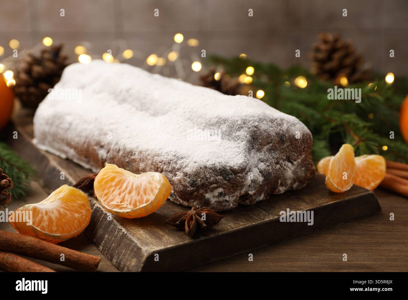Traditional Christmas Stollen with icing sugar, tangerine, spices and ...