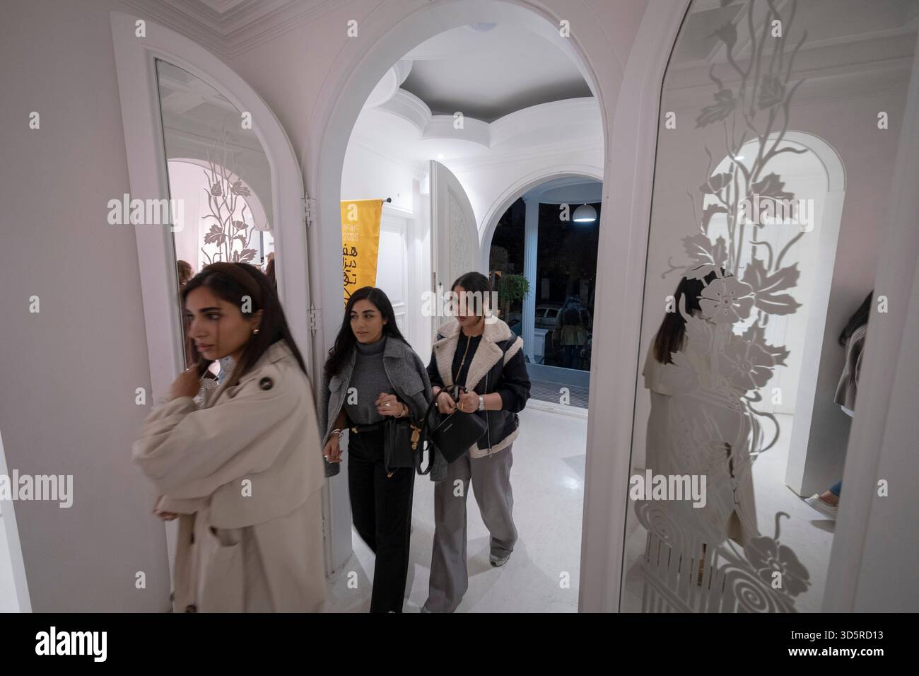 Young Iranian women arrive at a gallery to visit an interactive fashion ...
