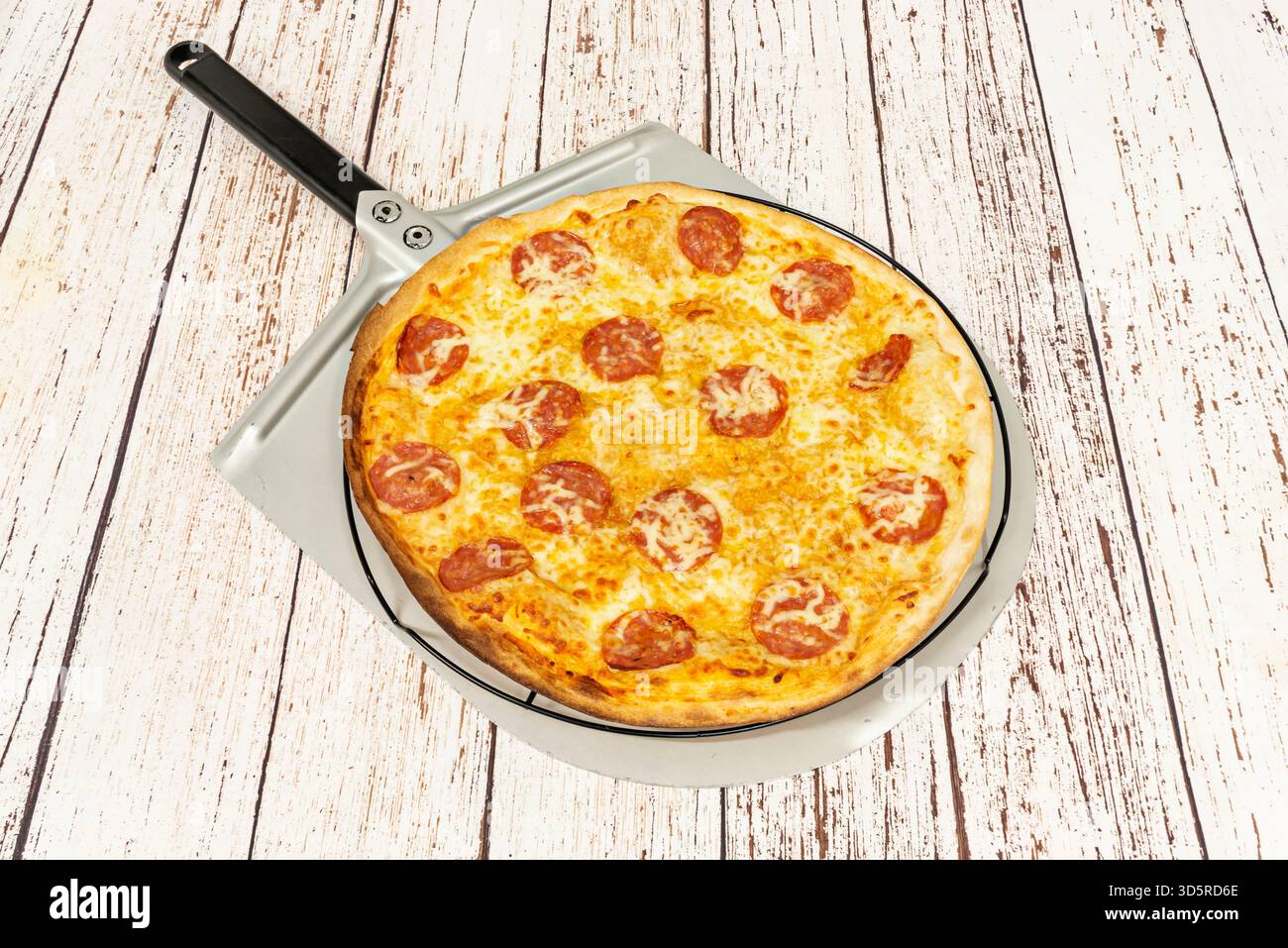 Slices of fresh green jalapeños intertwine with the spicy salami ...
