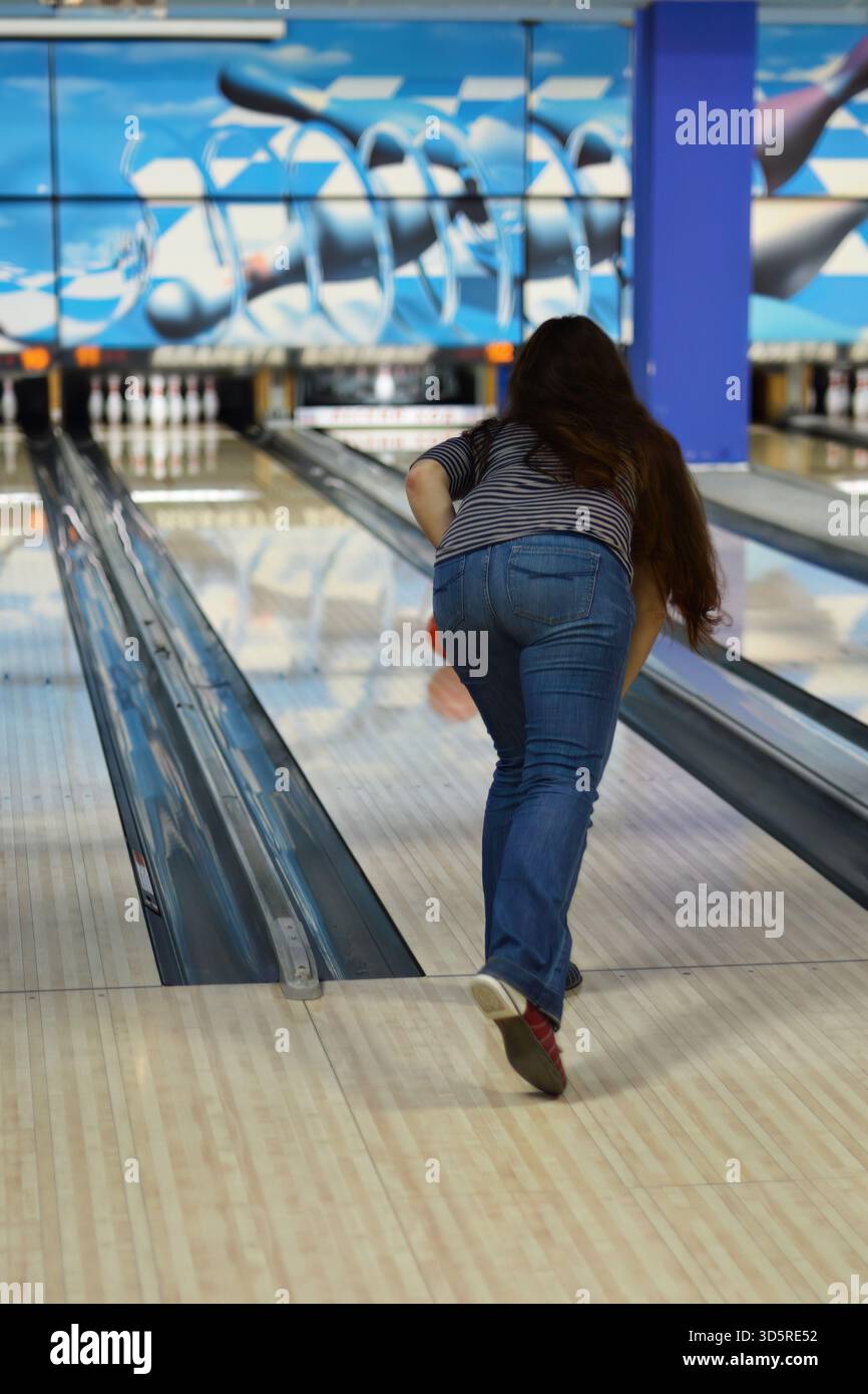 Woman bowling, rear view. Player in action Stock Photo - Alamy