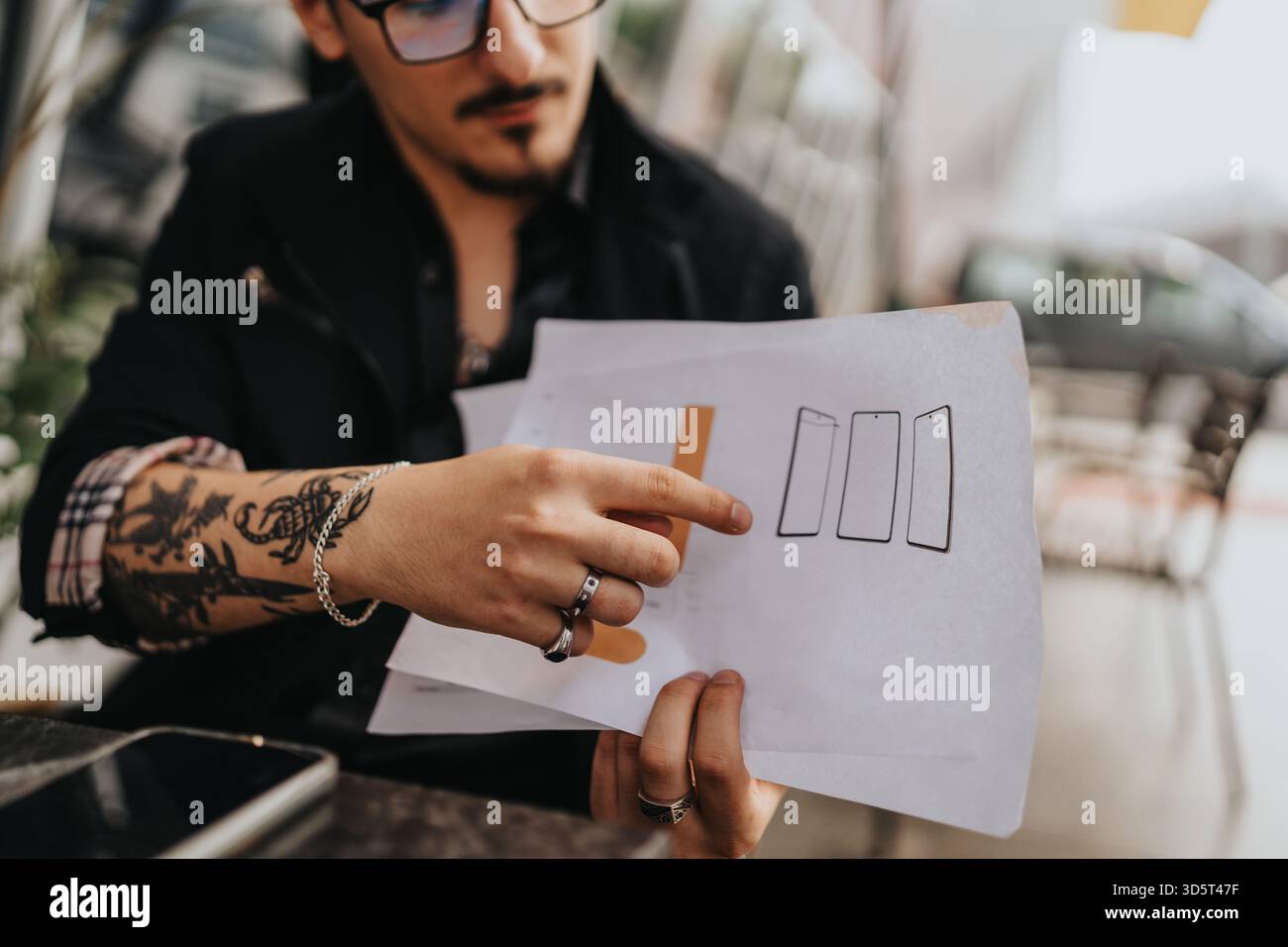 Person presenting ideas with hand-drawn sketches during a collaborative ...