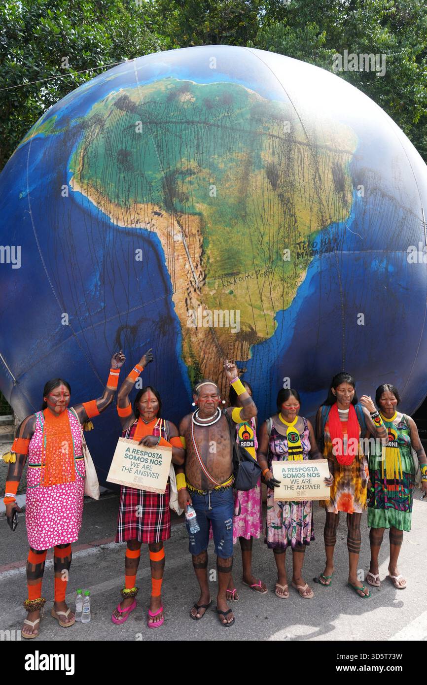 Indigenous activists pose for a photo in front of a globe at a climate ...