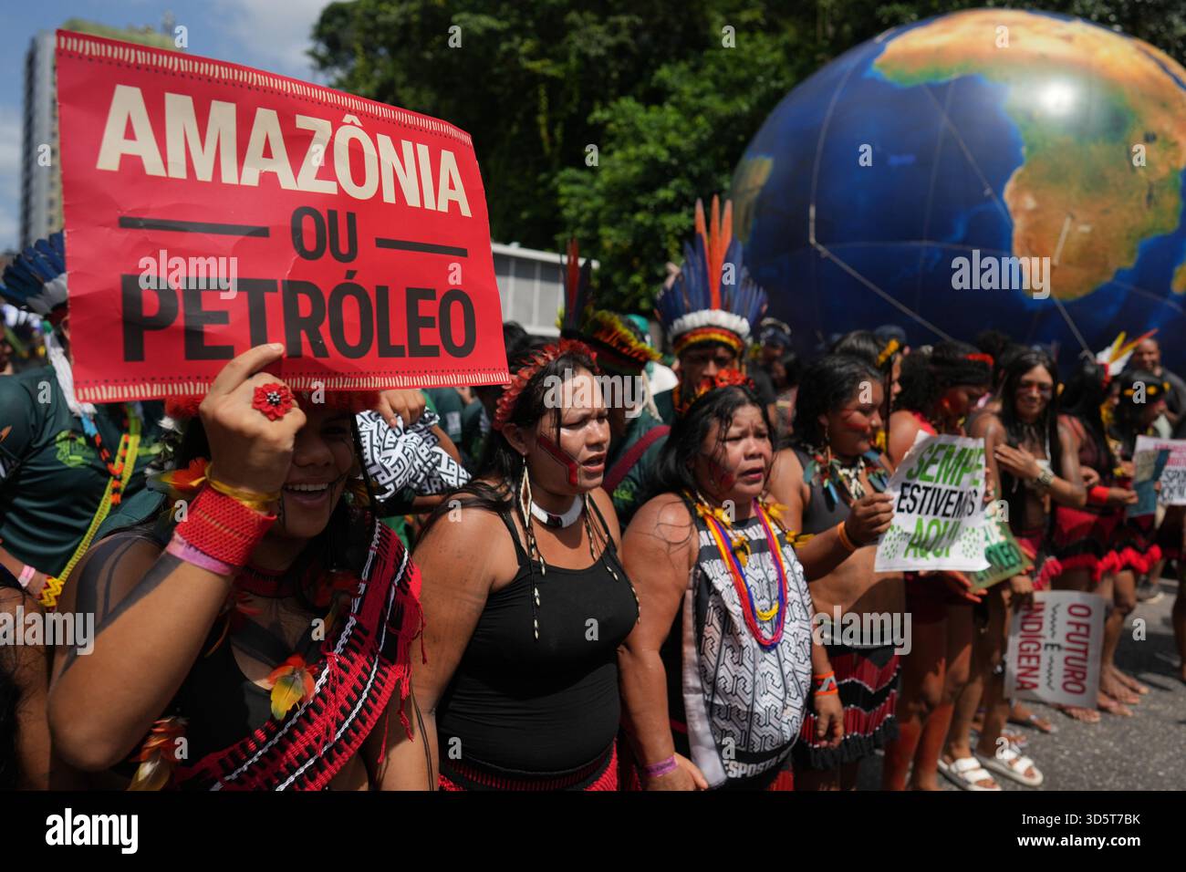 Indigenous activists participate in a climate protest during the COP30 ...