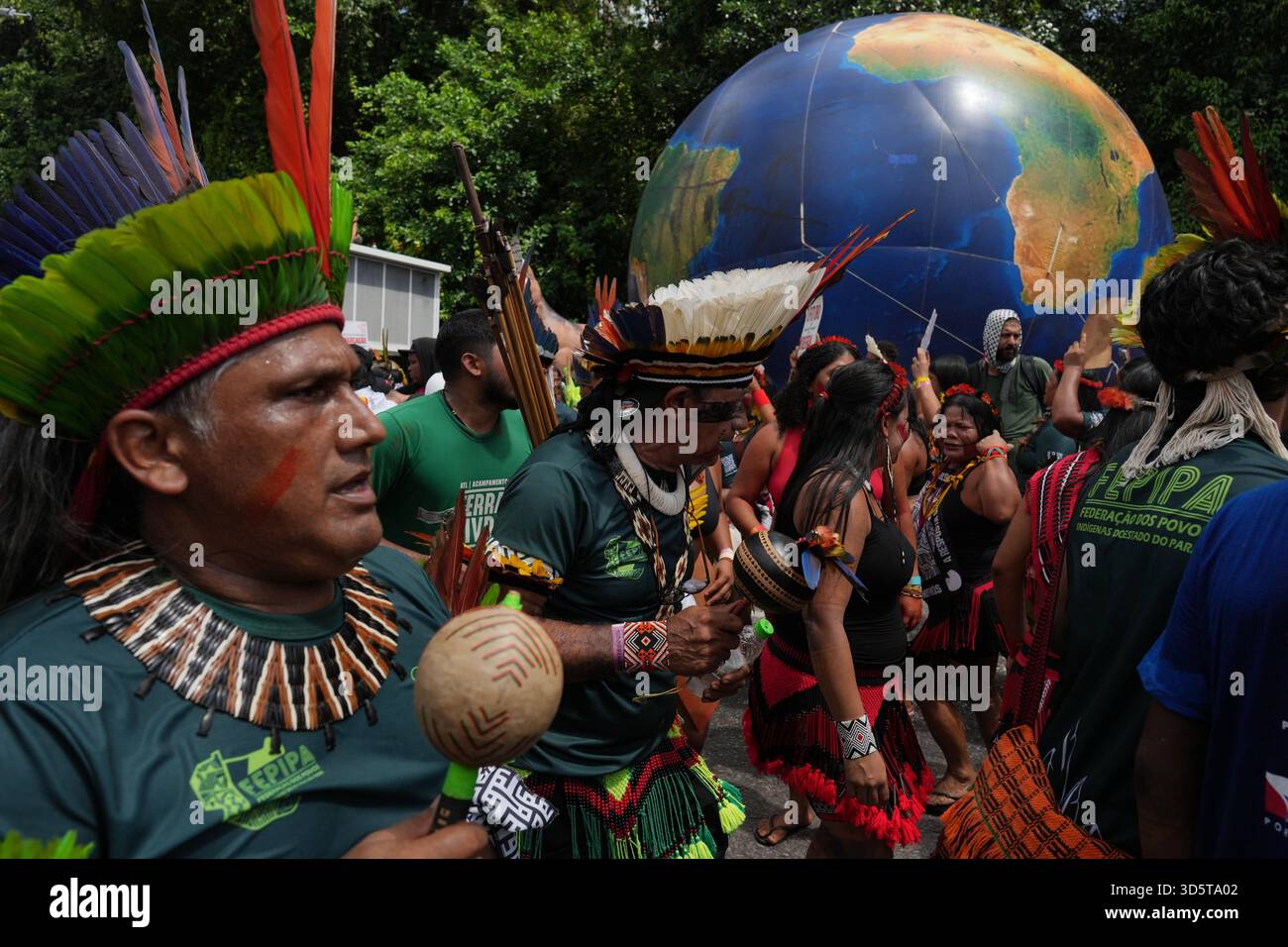 Indigenous activists participate in a climate protest during the COP30 ...