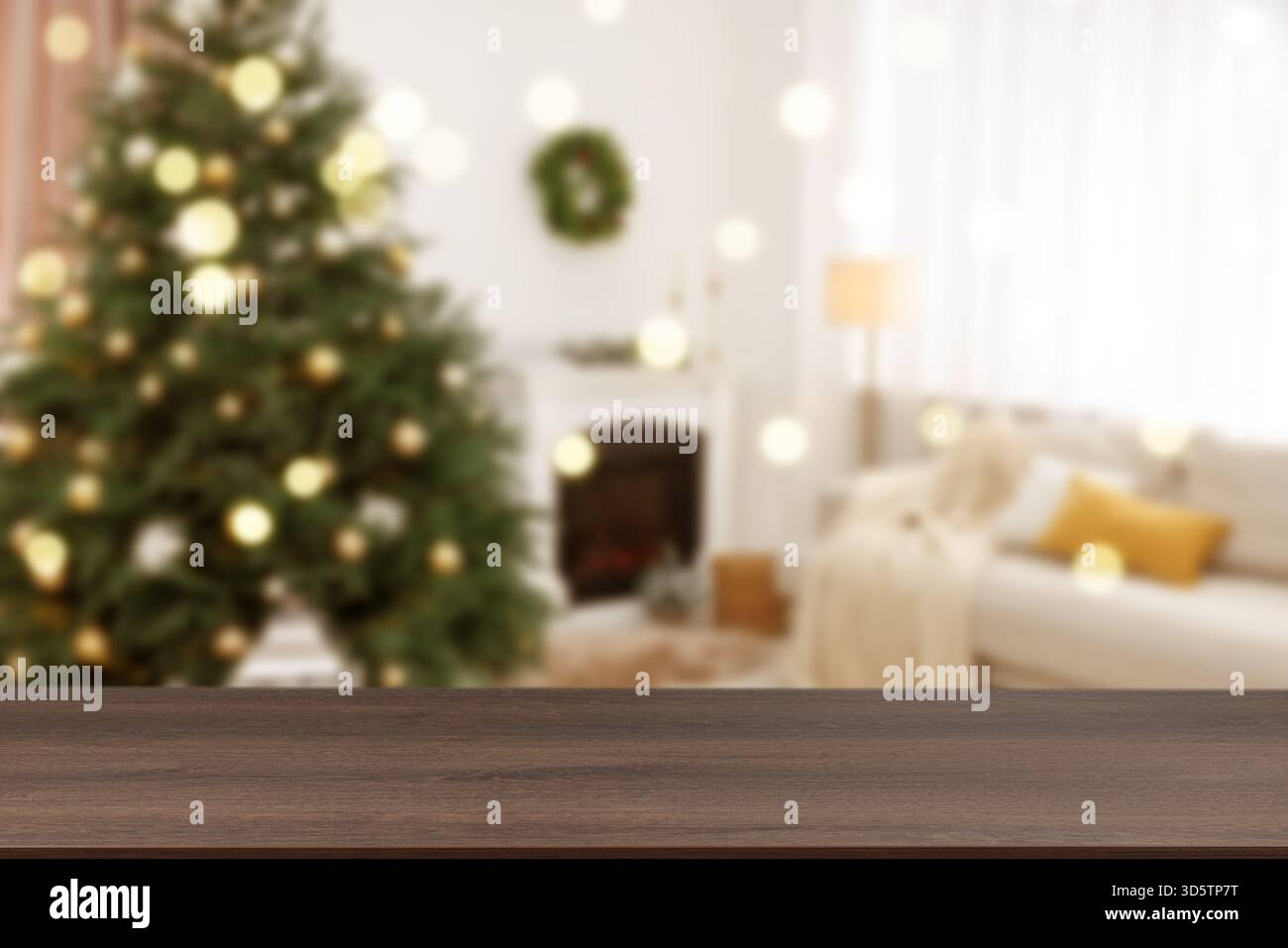 Empty wooden table against blurred room with Christmas tree, bokeh lights. Space for design ...