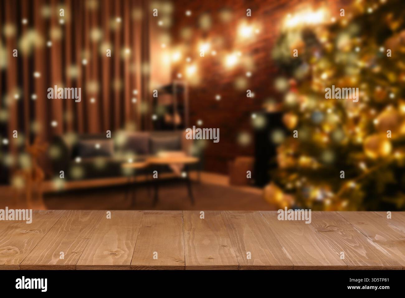 Empty wooden table against blurred room with Christmas tree, bokeh lights. Space for design ...