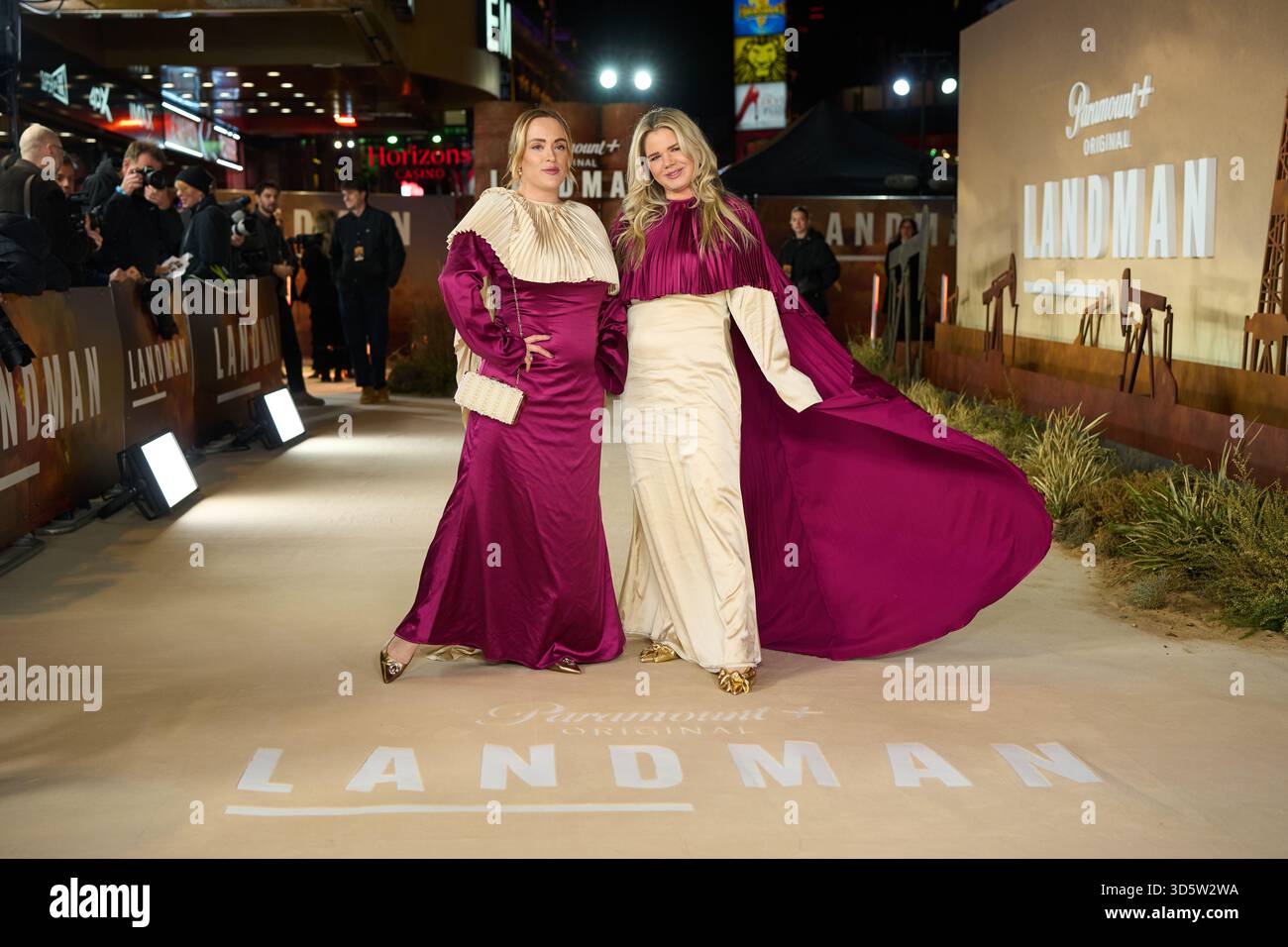 Whitney Bacon-Evans, left, and Megan Bacon-Evans pose for photographers ...