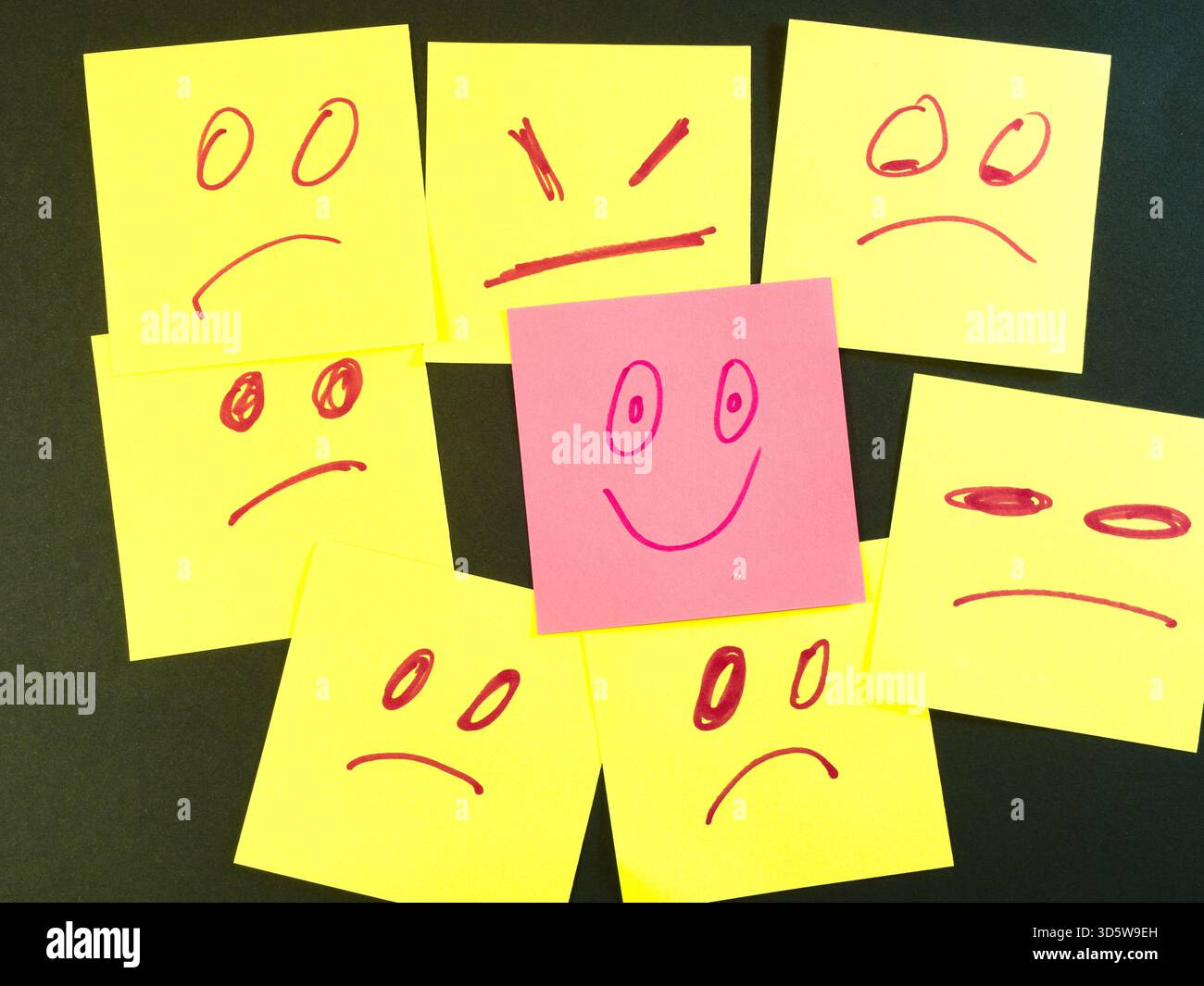 Happy Face Stands Out in Crowd of Sad - One pink sticky note with a ...