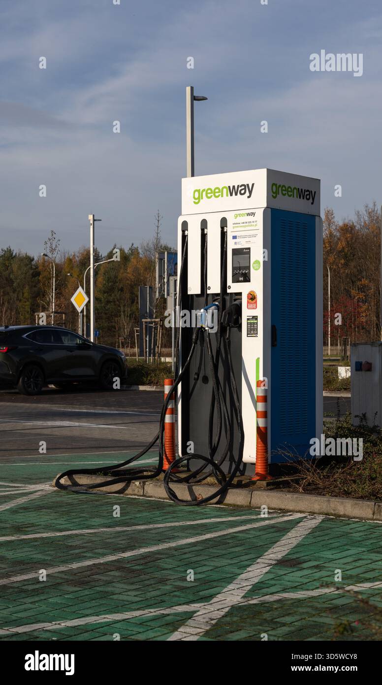Electric vehicle charging station at a roadside location in bright ...