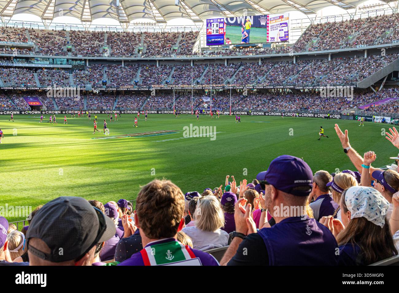 Fans watching Fremantle Dockers play the Sydney Swans at Aussie Rules ...