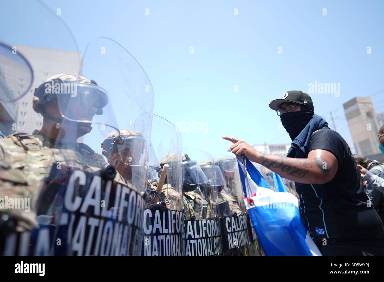 FILE - A protester confronts a line of U.S. National Guard in the ...