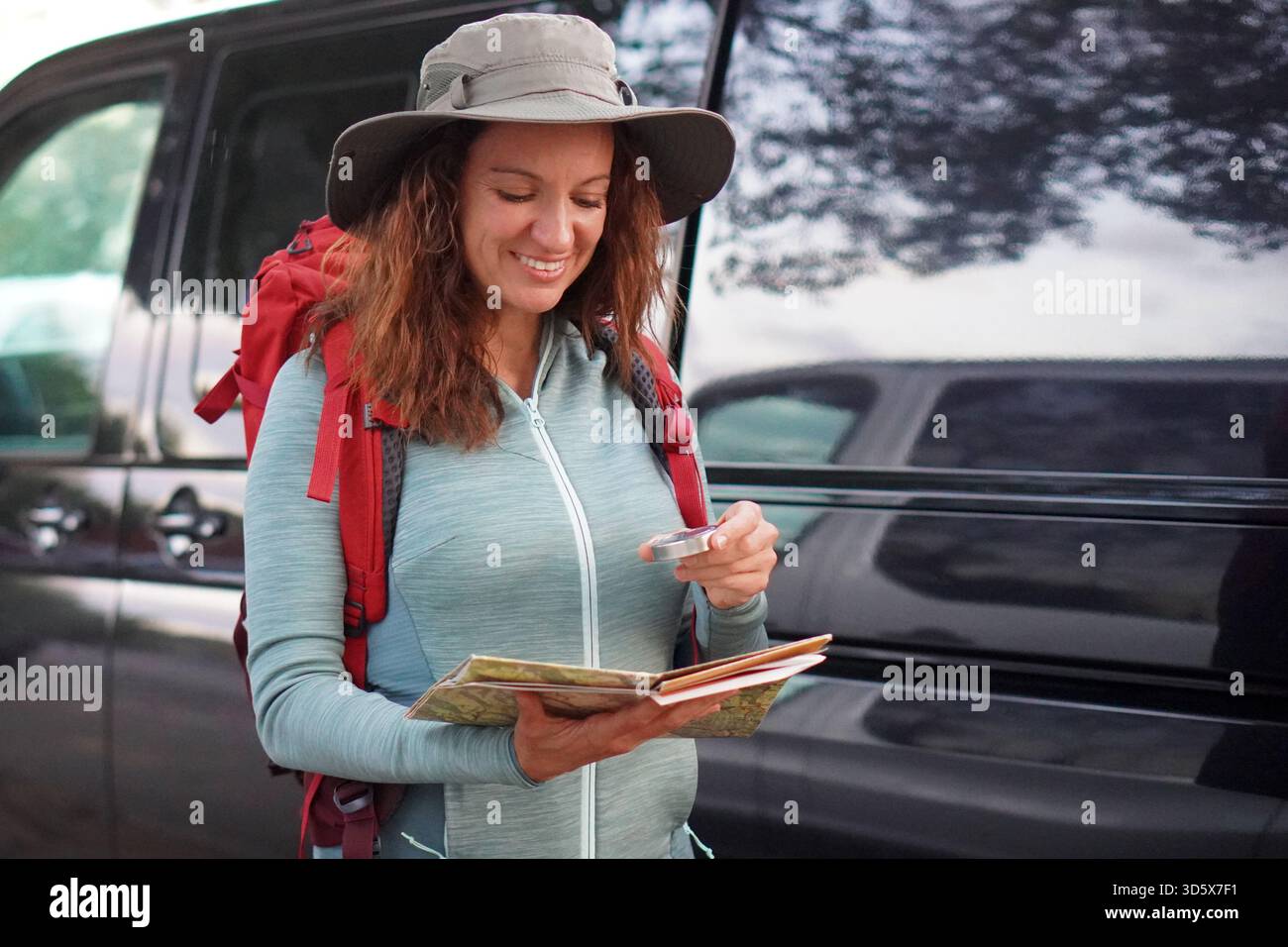 adventure and outdoor activities. Woman with curly hair wearing a ...