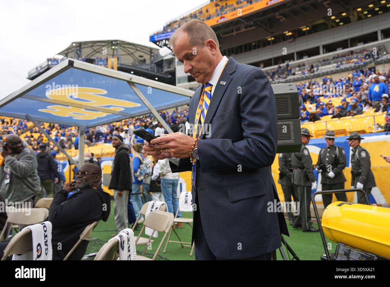 ACC Commissioner Jim Phillips checks his phone on the field before an ...