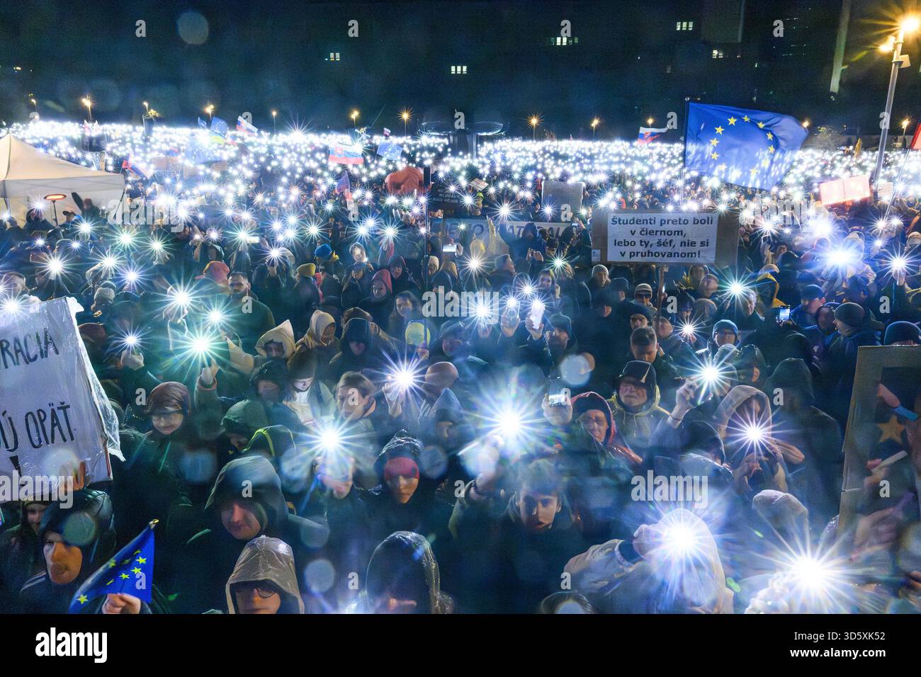 People hold mobile phones with flashlights during a rally to celebrate ...