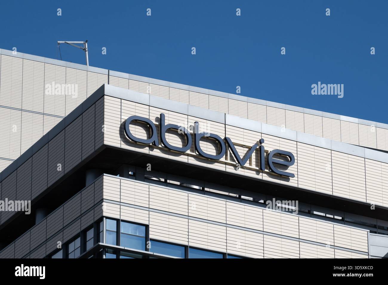 AbbVie logo on modern office building facade against clear blue sky ...