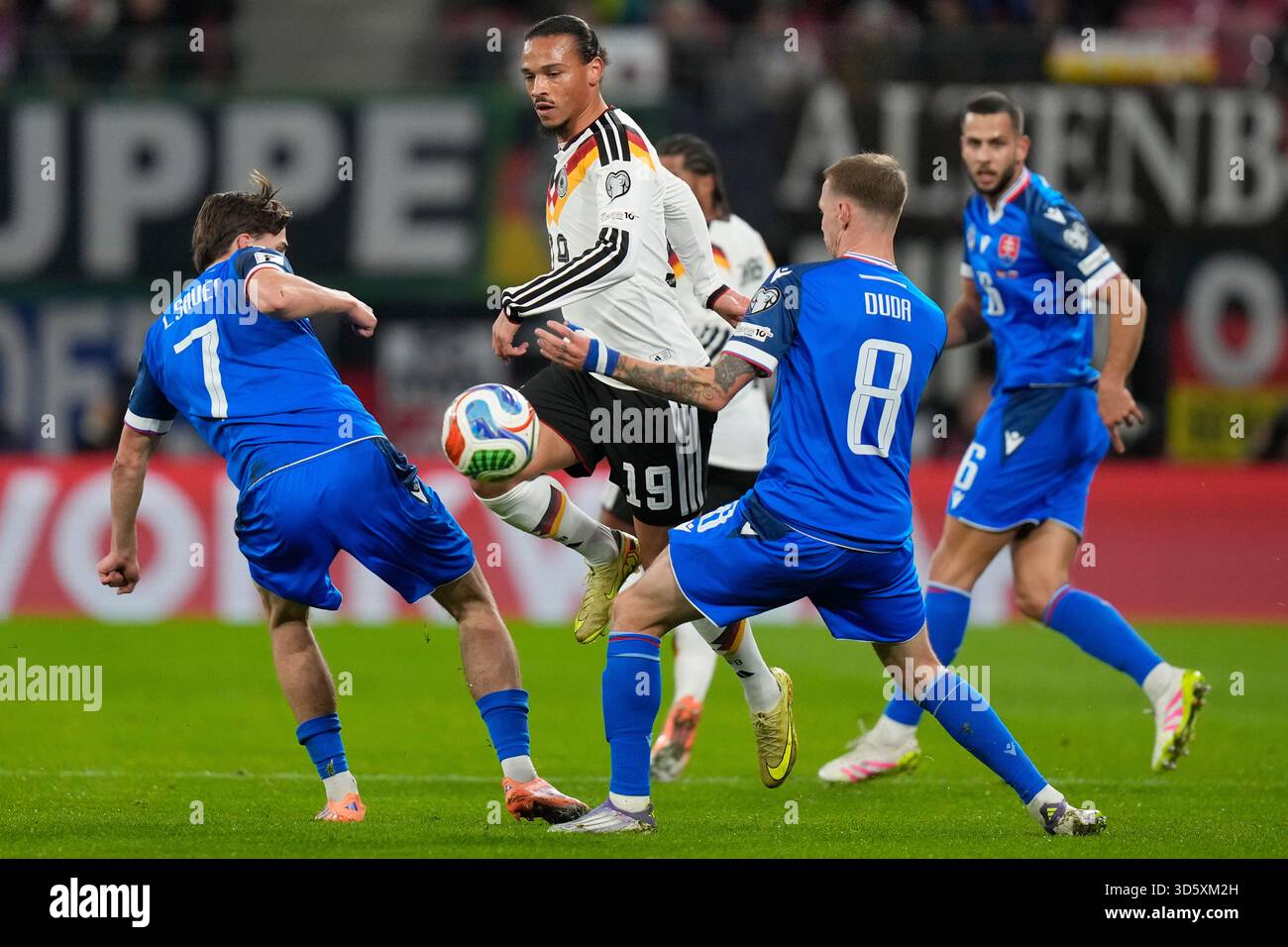 Germany's Leroy Sané in action between Slovakia's Leo Sauer, left, and Ondrej Duda during a ...