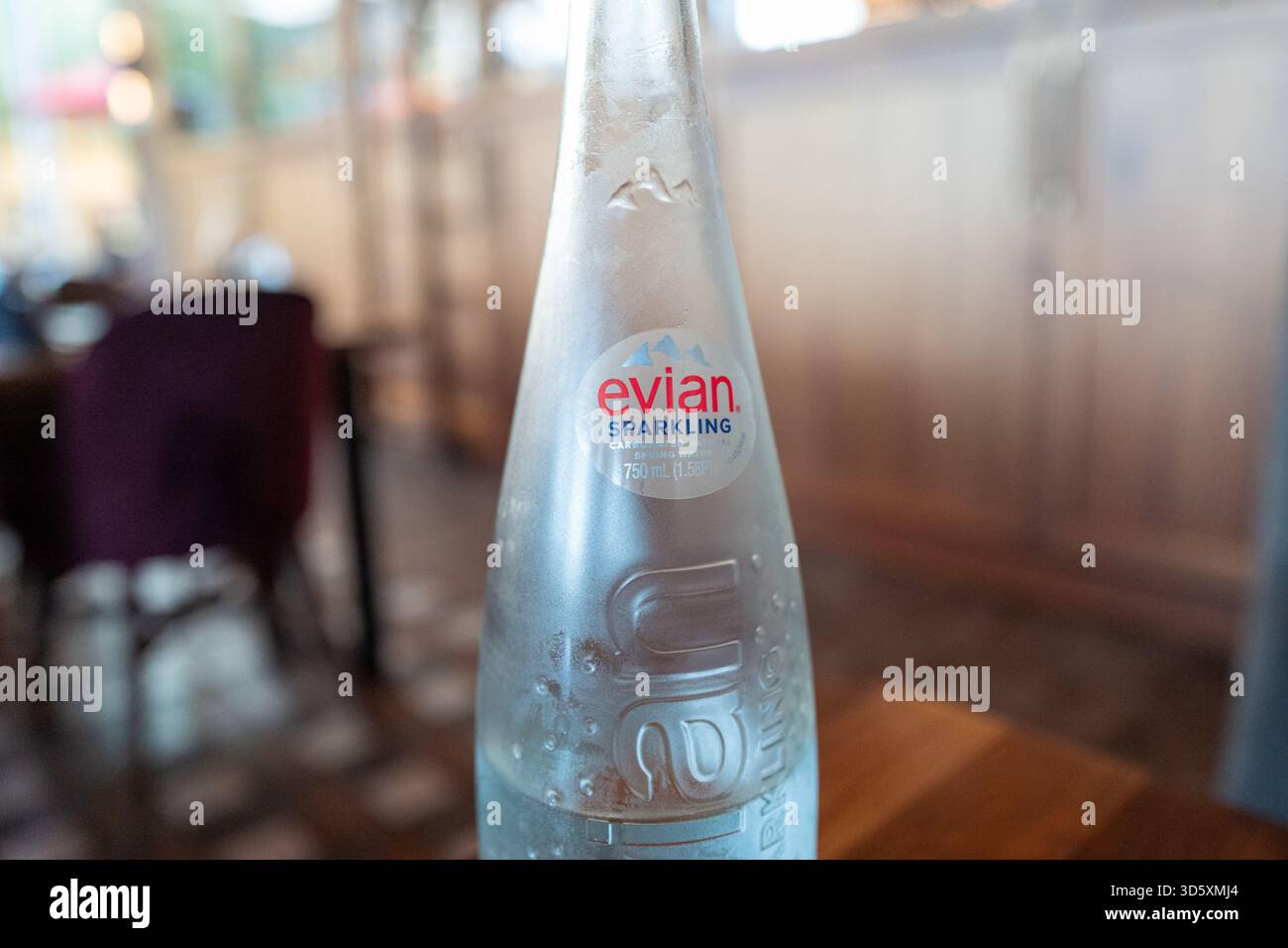 Close-up of logo on a bottle of Evian water on a restaurant table, San ...