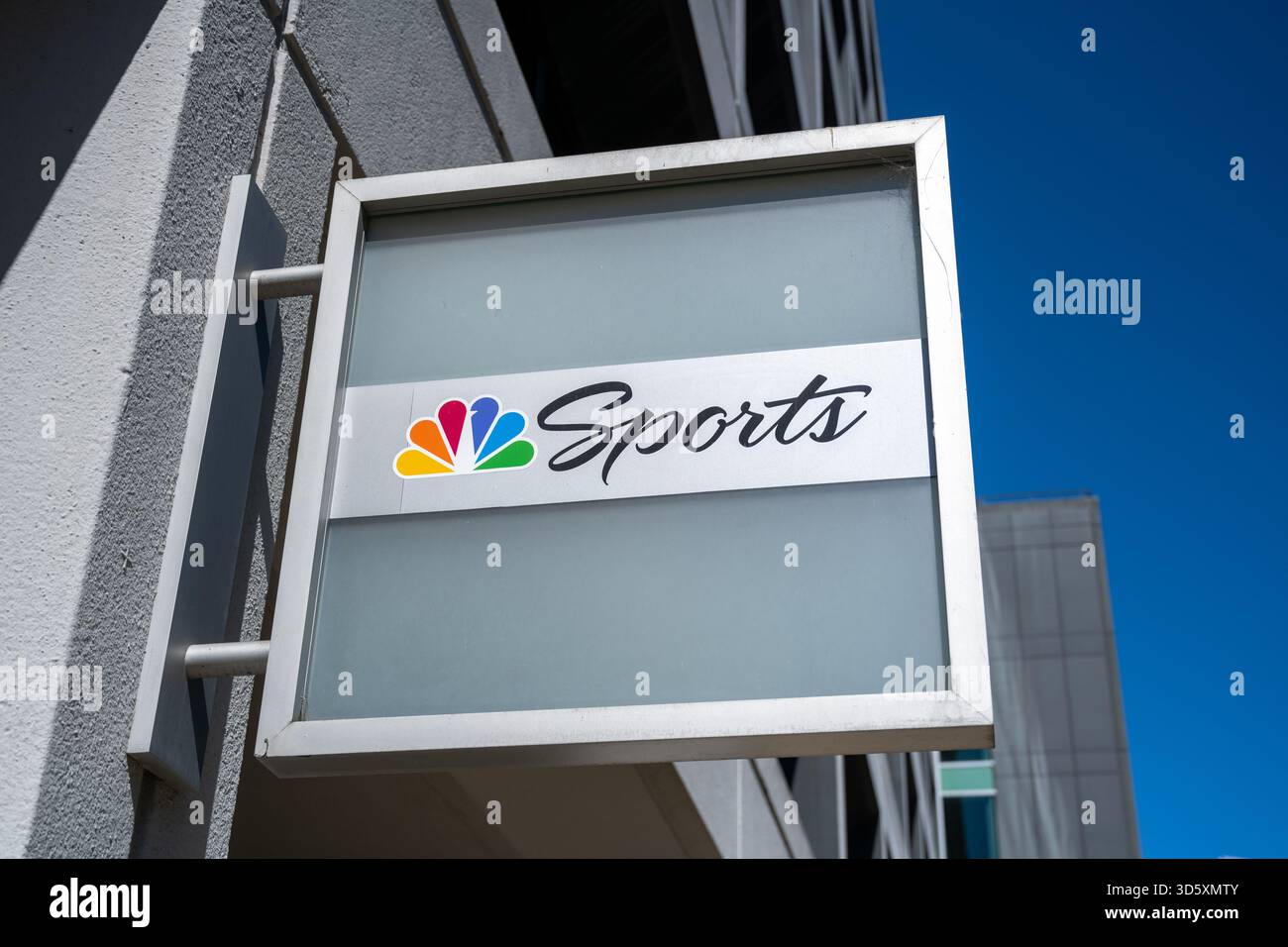 Hanging NBC Sports logo sign mounted on office building facade under ...