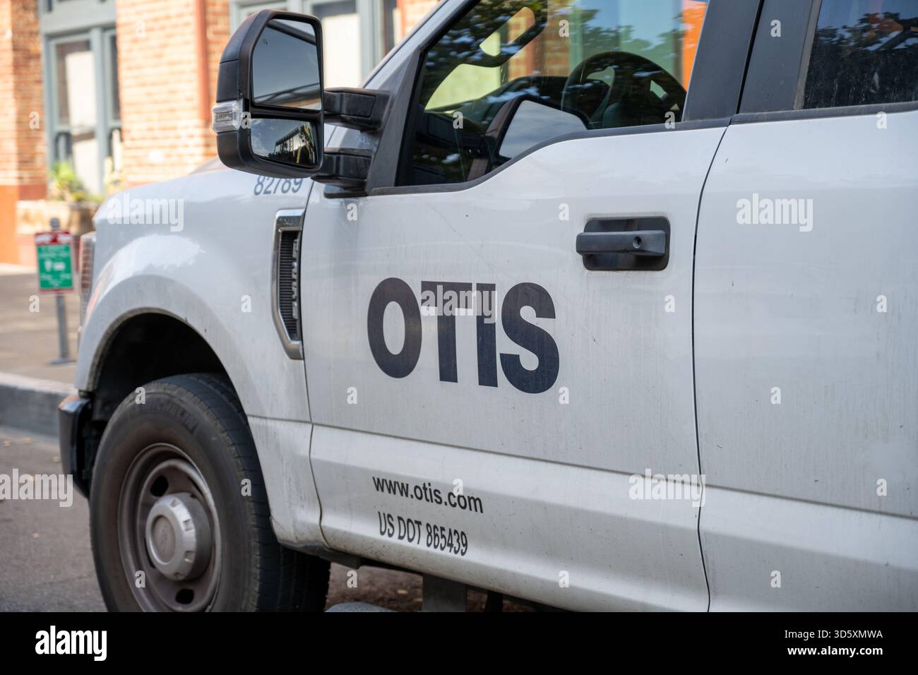 Close-up of Otis service truck with logo on door parked on urban street ...