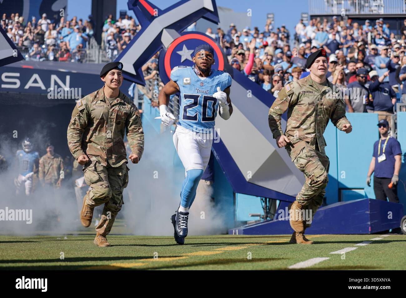 Tennessee Titans running back Tony Pollard (20) is escorted by members ...
